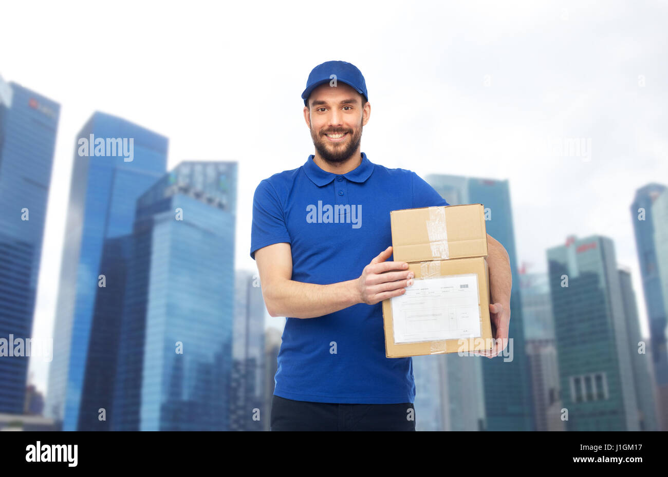 happy delivery man with parcel boxes Stock Photo - Alamy
