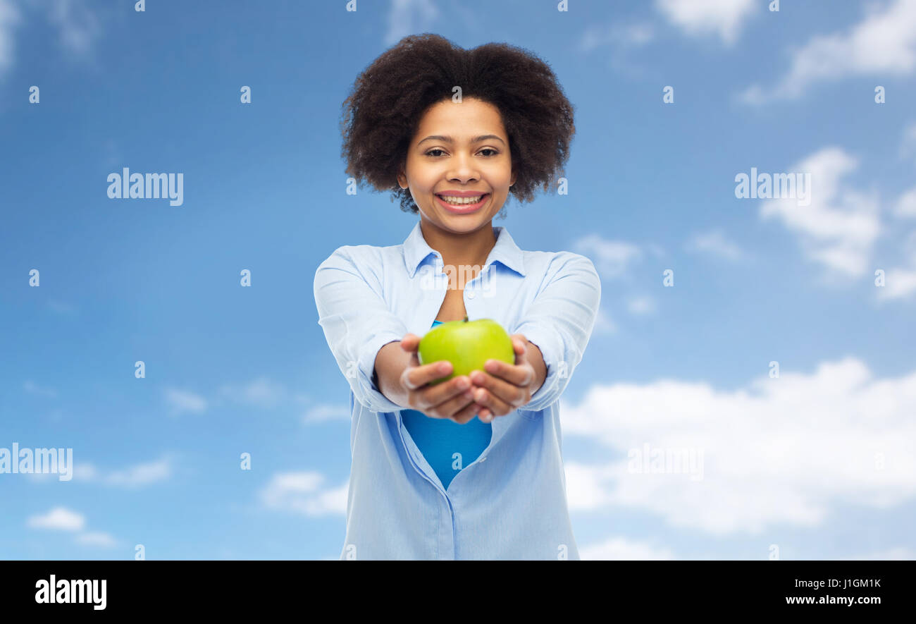 happy african american woman with green apple Stock Photo - Alamy