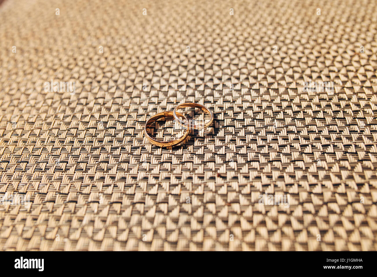 Wedding rings on a textured background Stock Photo - Alamy