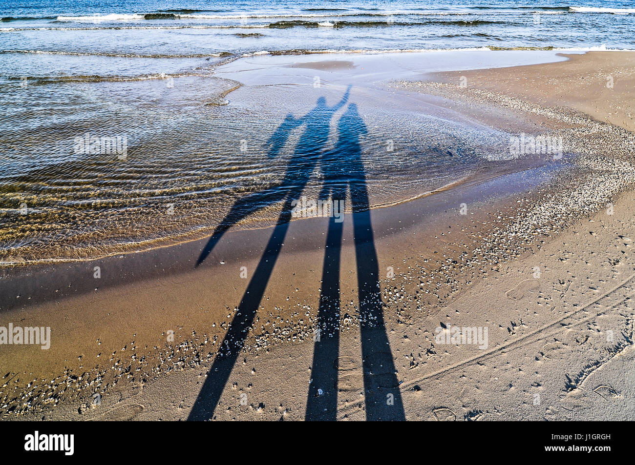 Human shadows on a beach hi-res stock photography and images - Alamy