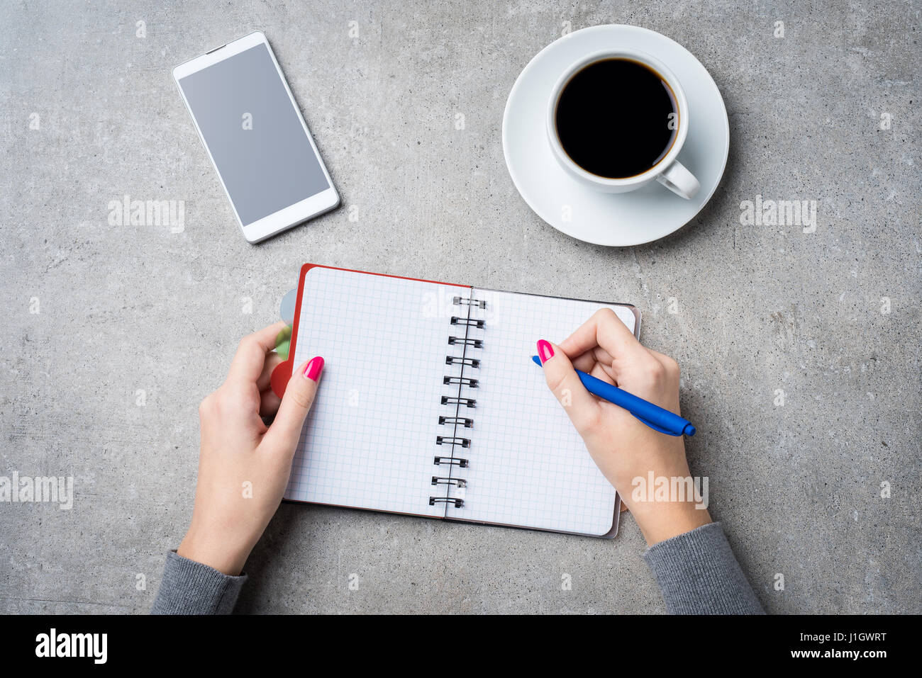 Woman writing in empty notebook Stock Photo - Alamy