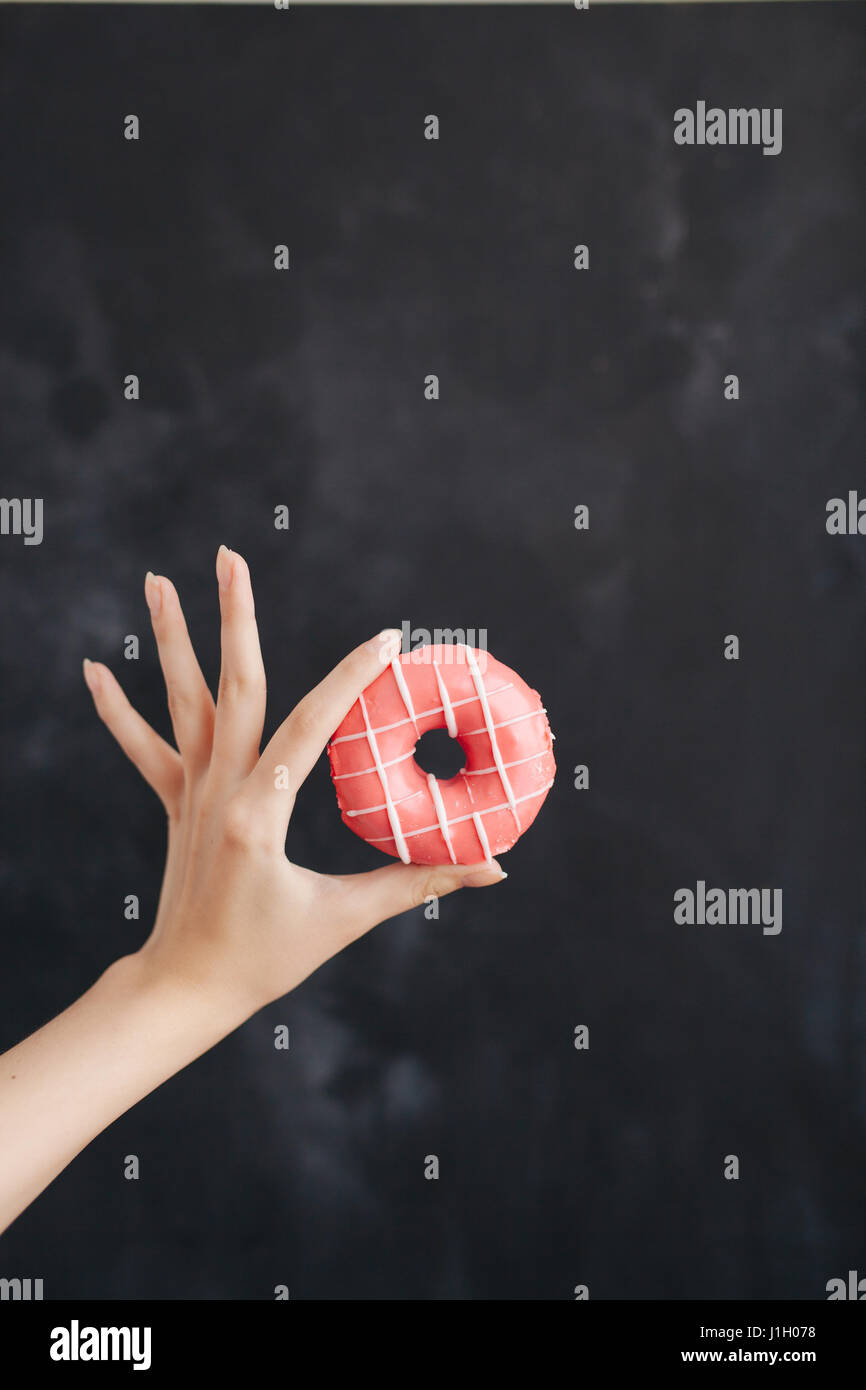 Donut in hand hi-res stock photography and images - Alamy