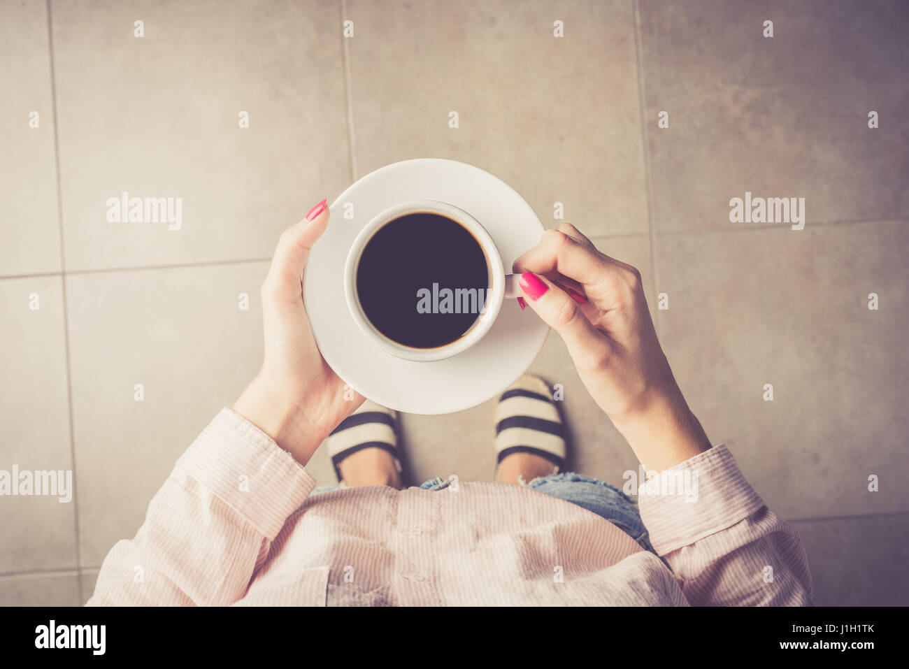 Overhead shot of fashionable woman holding cup of coffee Stock Photo ...
