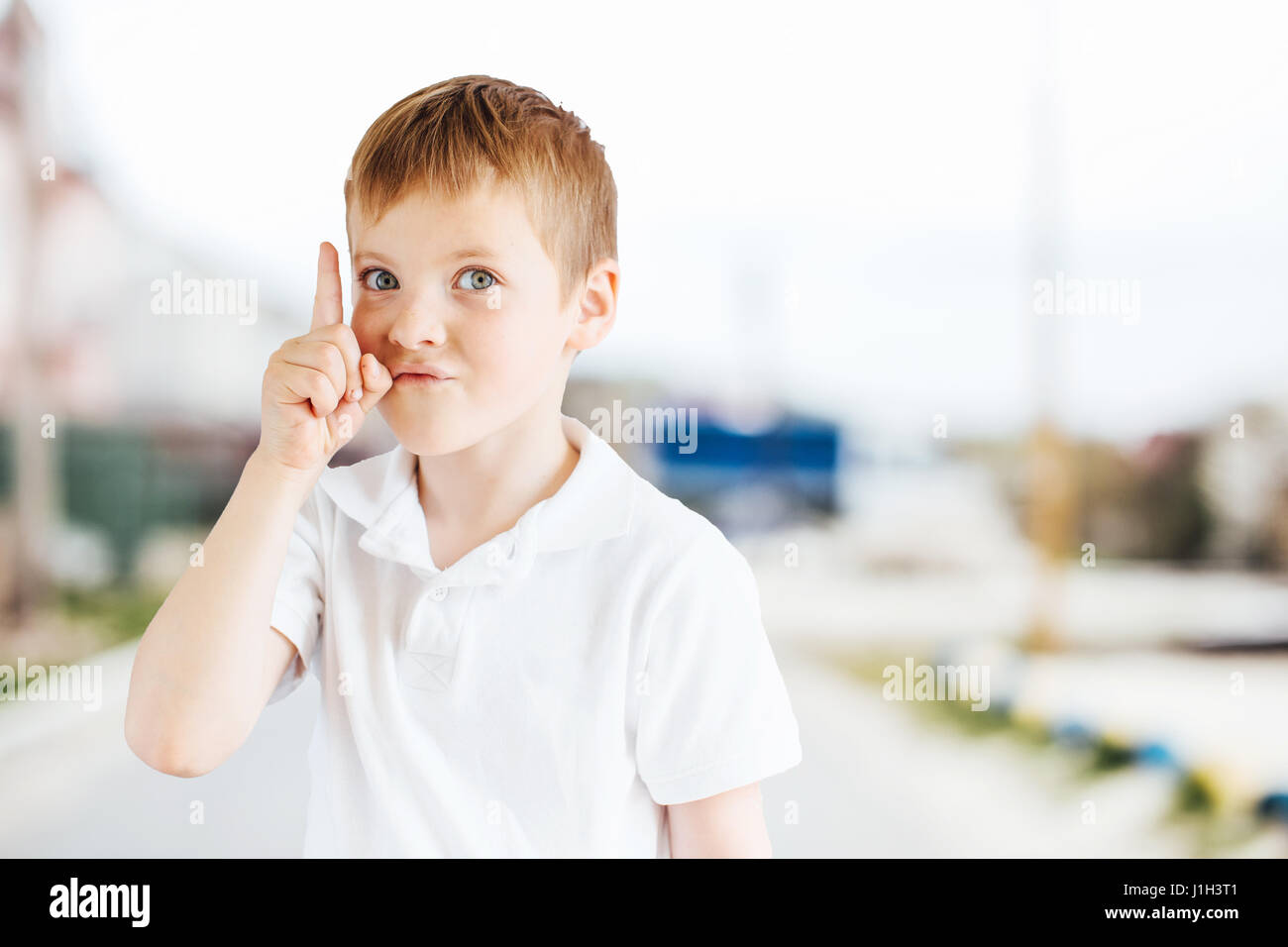 Little boy show emotions at park background with light Stock Photo - Alamy
