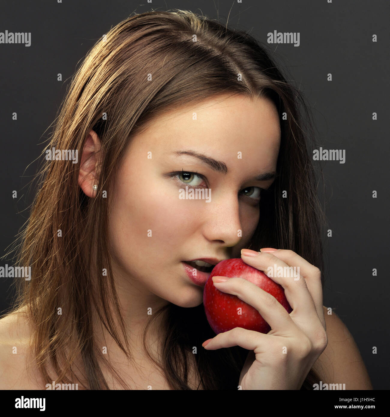 Beautiful woman posing with red apple Stock Photo - Alamy