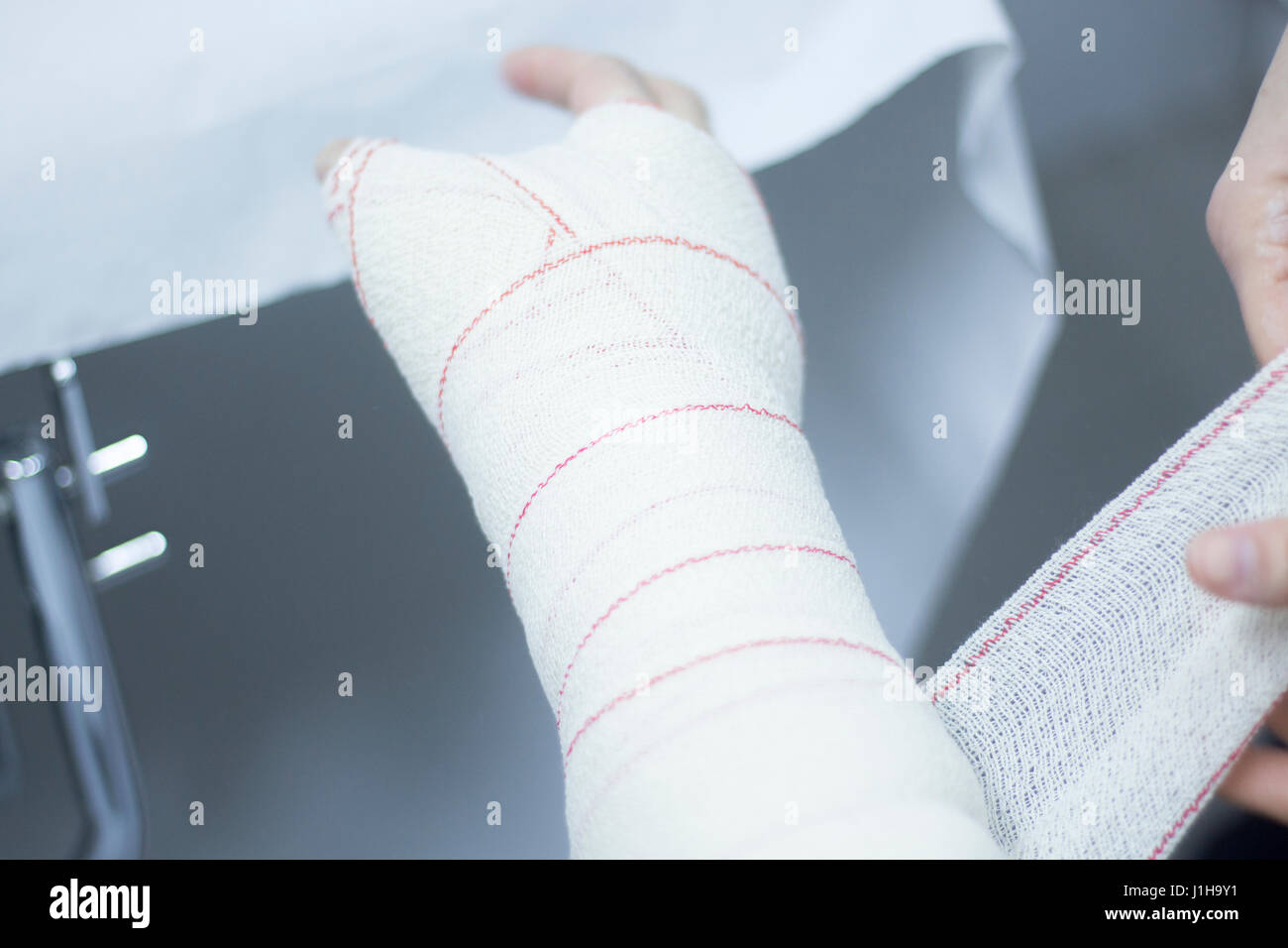 Doctor applying plaster cast bandages hi-res stock photography and ...