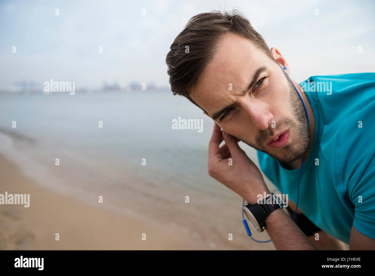 Exhausted man after the jogging Stock Photo - Alamy
