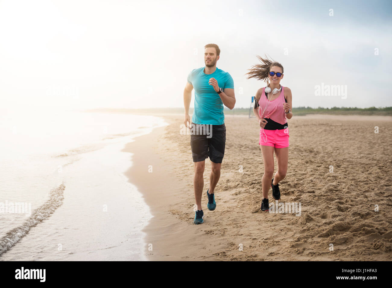 We love morning jogging on the beach Stock Photo - Alamy