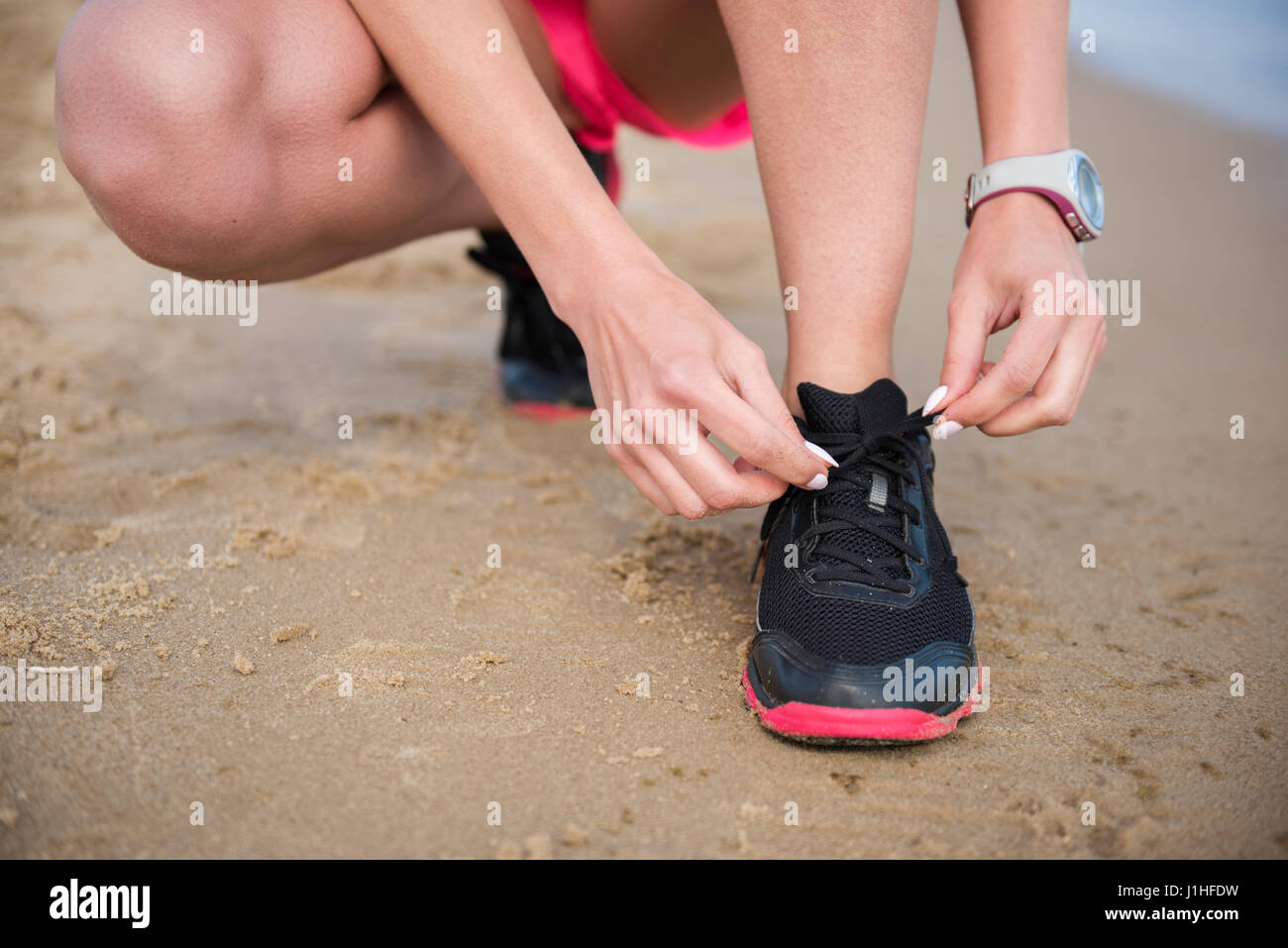 Woman tying a sport shoes Stock Photo - Alamy