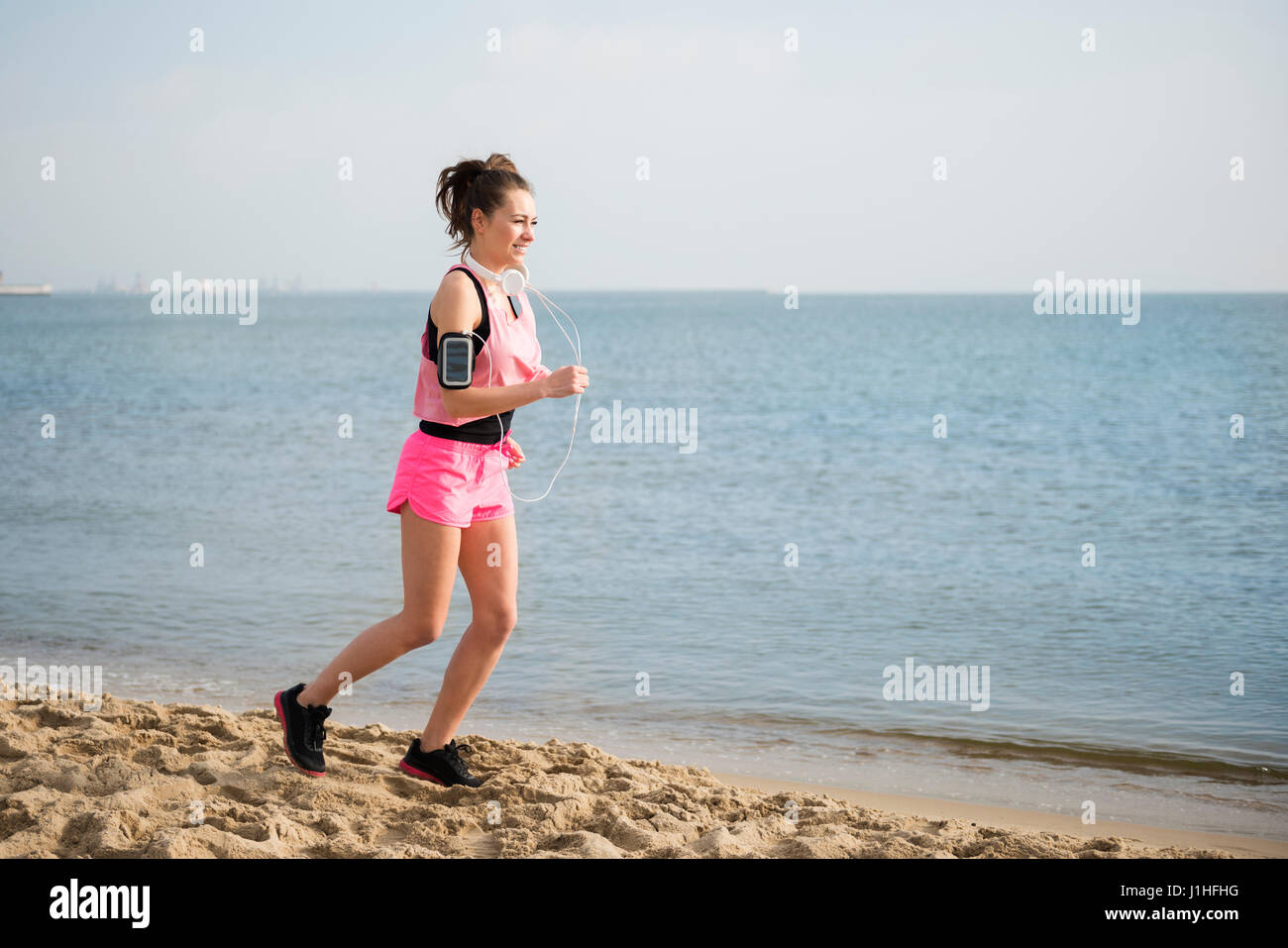 Female athlete running across sand hi-res stock photography and images ...