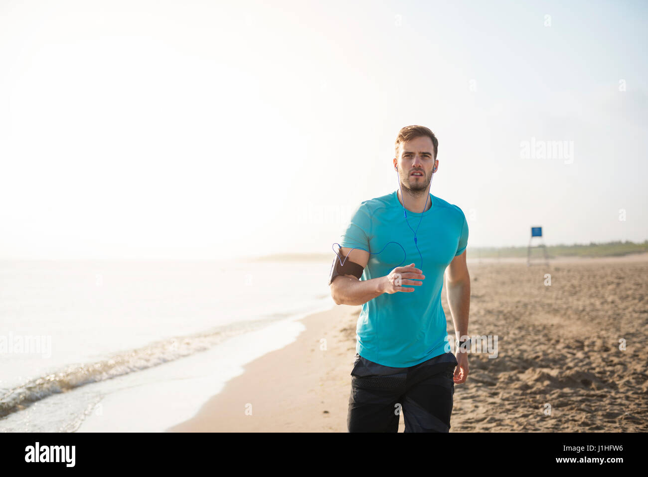 Front view of jogging man Stock Photo - Alamy