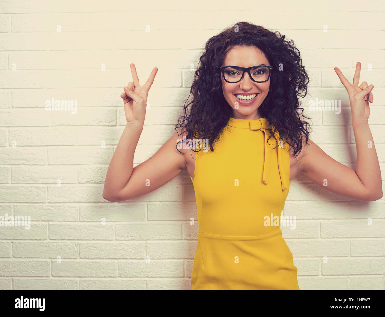 Closeup happy, smiling, confident, woman giving peace victory, two sign ...