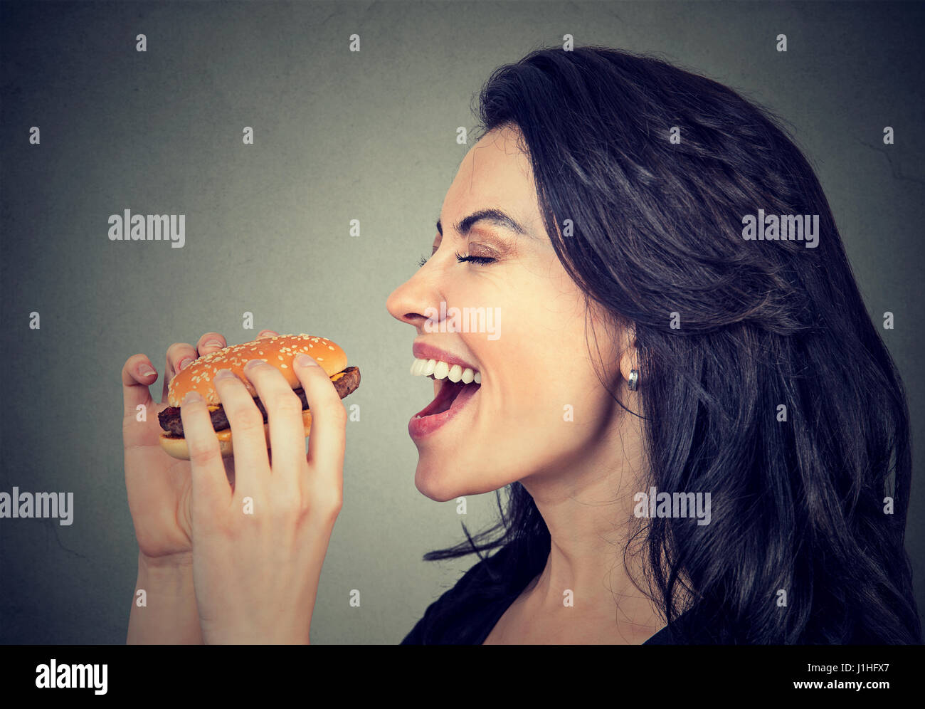 Attractive woman eating burger hi-res stock photography and images - Alamy
