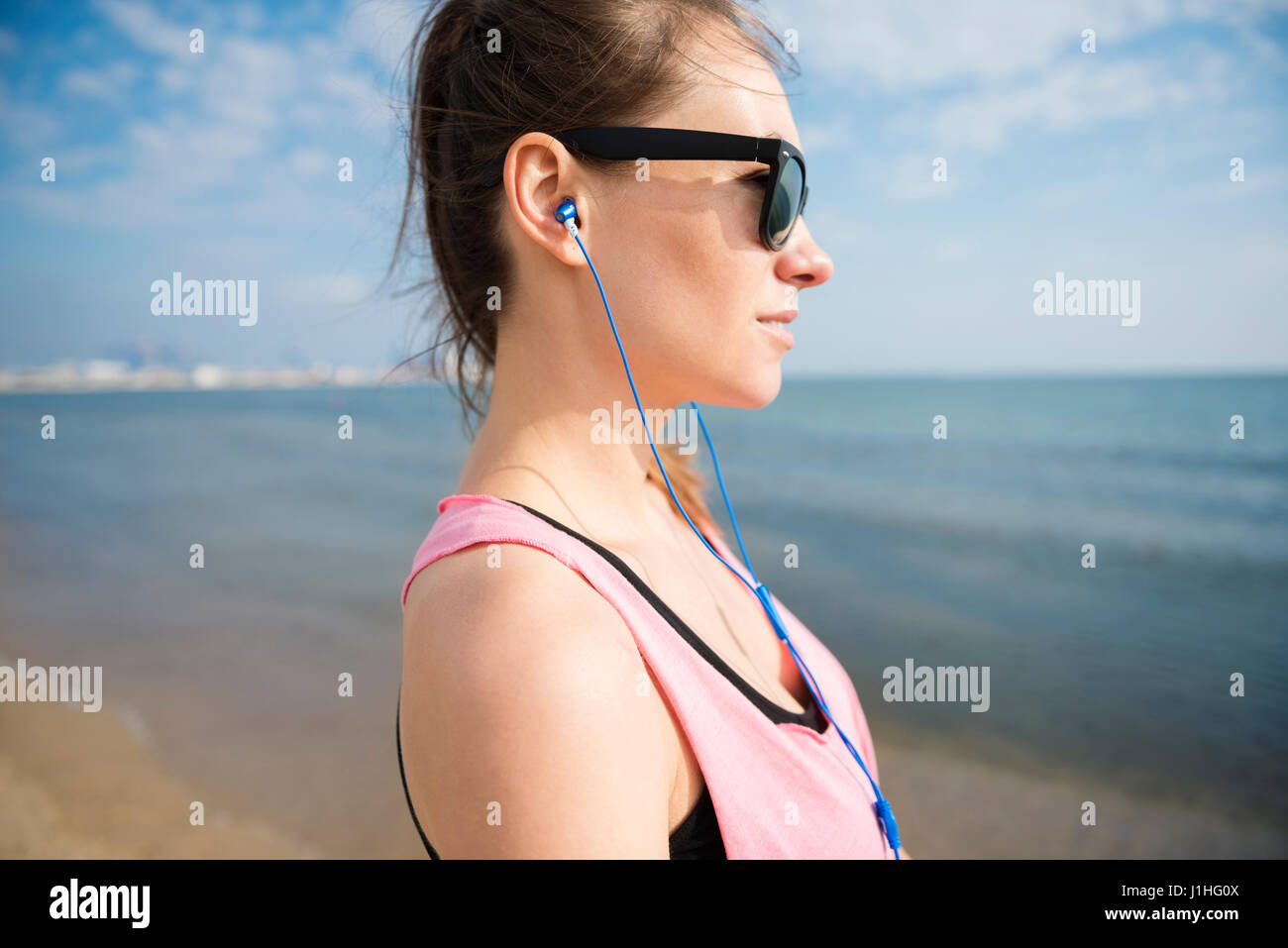 Side view of woman on the beach Stock Photo - Alamy