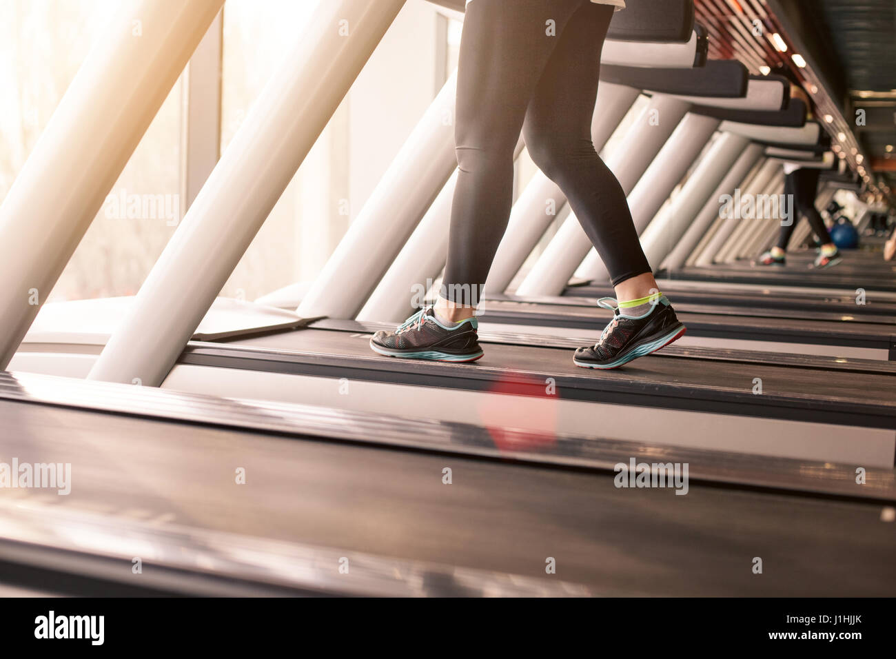 Woman running in a gym on a treadmill concept for exercising, fitness ...