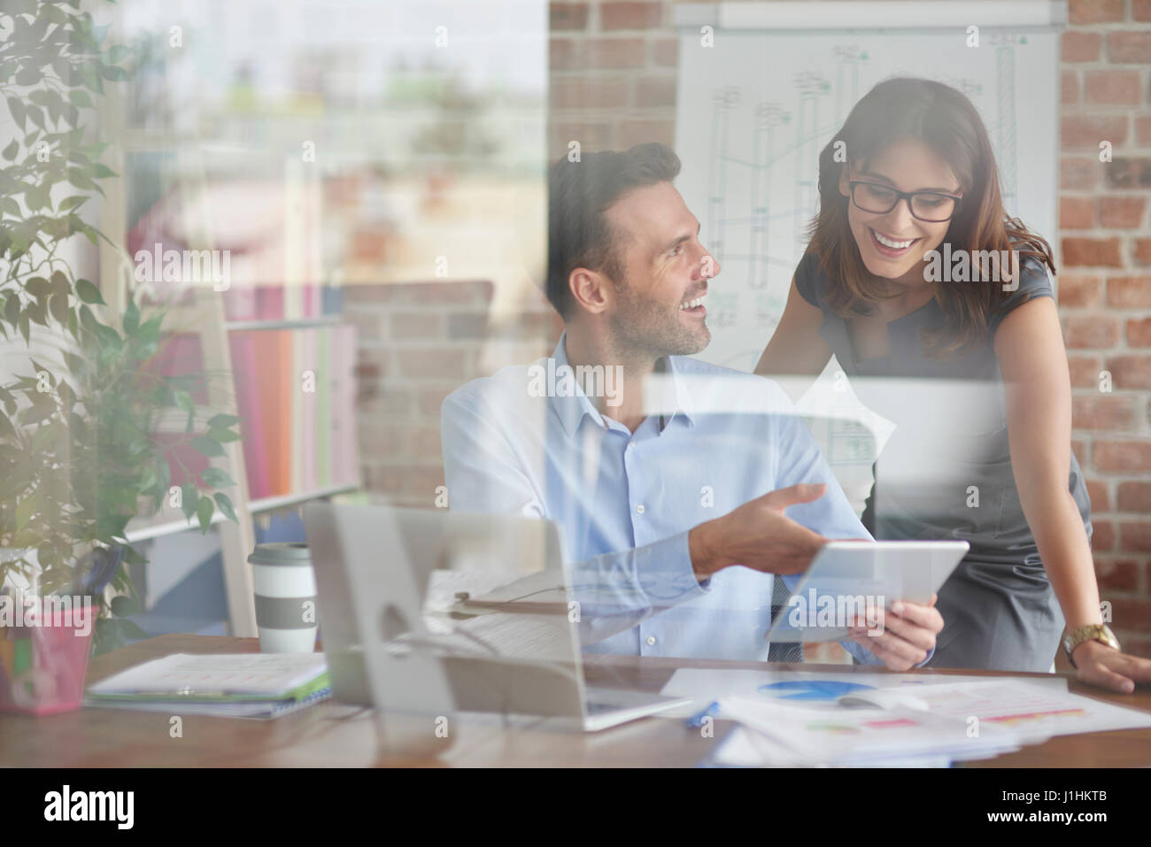 View through glass wall on the office Stock Photo - Alamy
