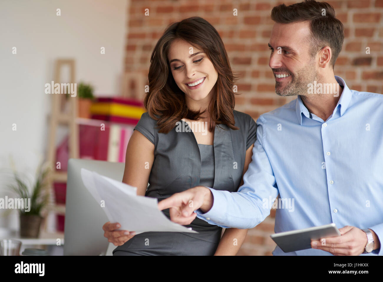 Checking some documents in good mood Stock Photo - Alamy