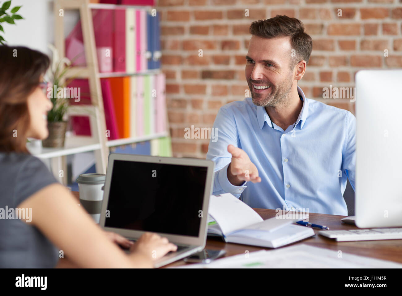 Two coworkers talking using hi-res stock photography and images - Alamy