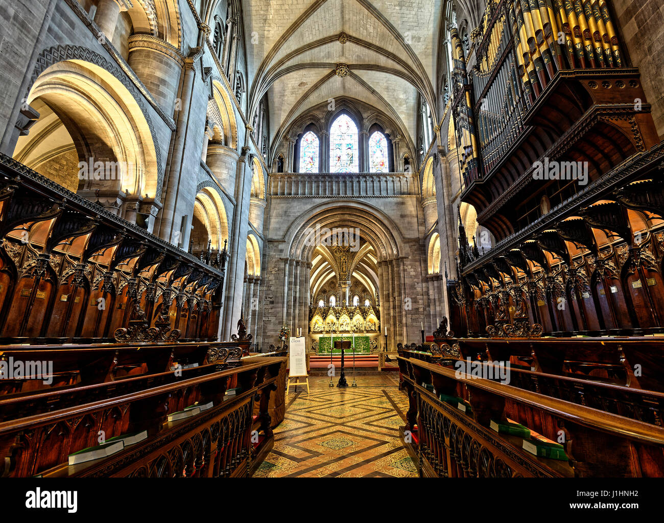 Carved Choir stalls in Hereford Cathedral looking towards the altar ...