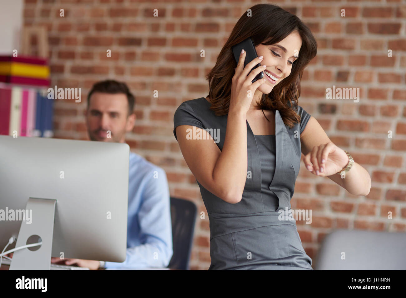 Woman checking her time of work Stock Photo - Alamy