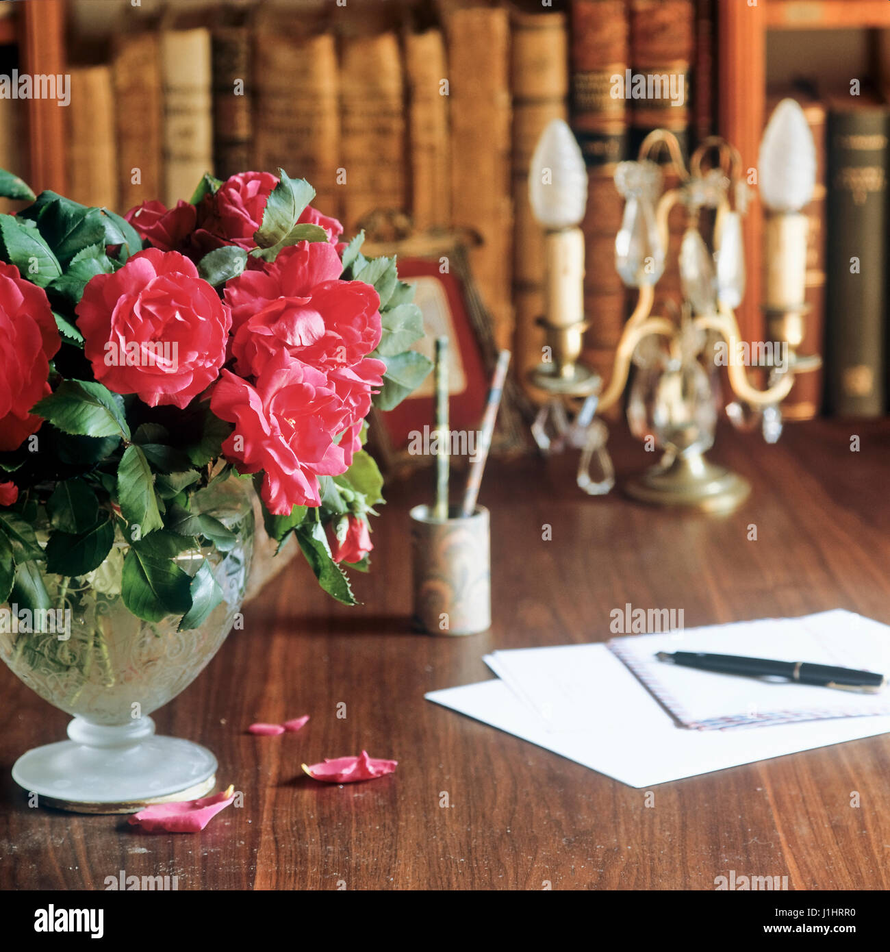 Flowers and pens on desk Stock Photo - Alamy