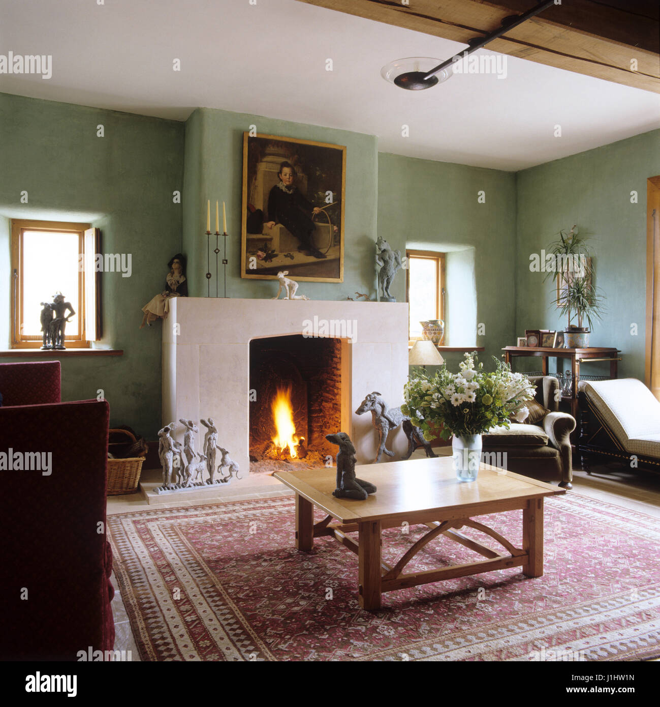 Living room with lit fireplace Stock Photo - Alamy