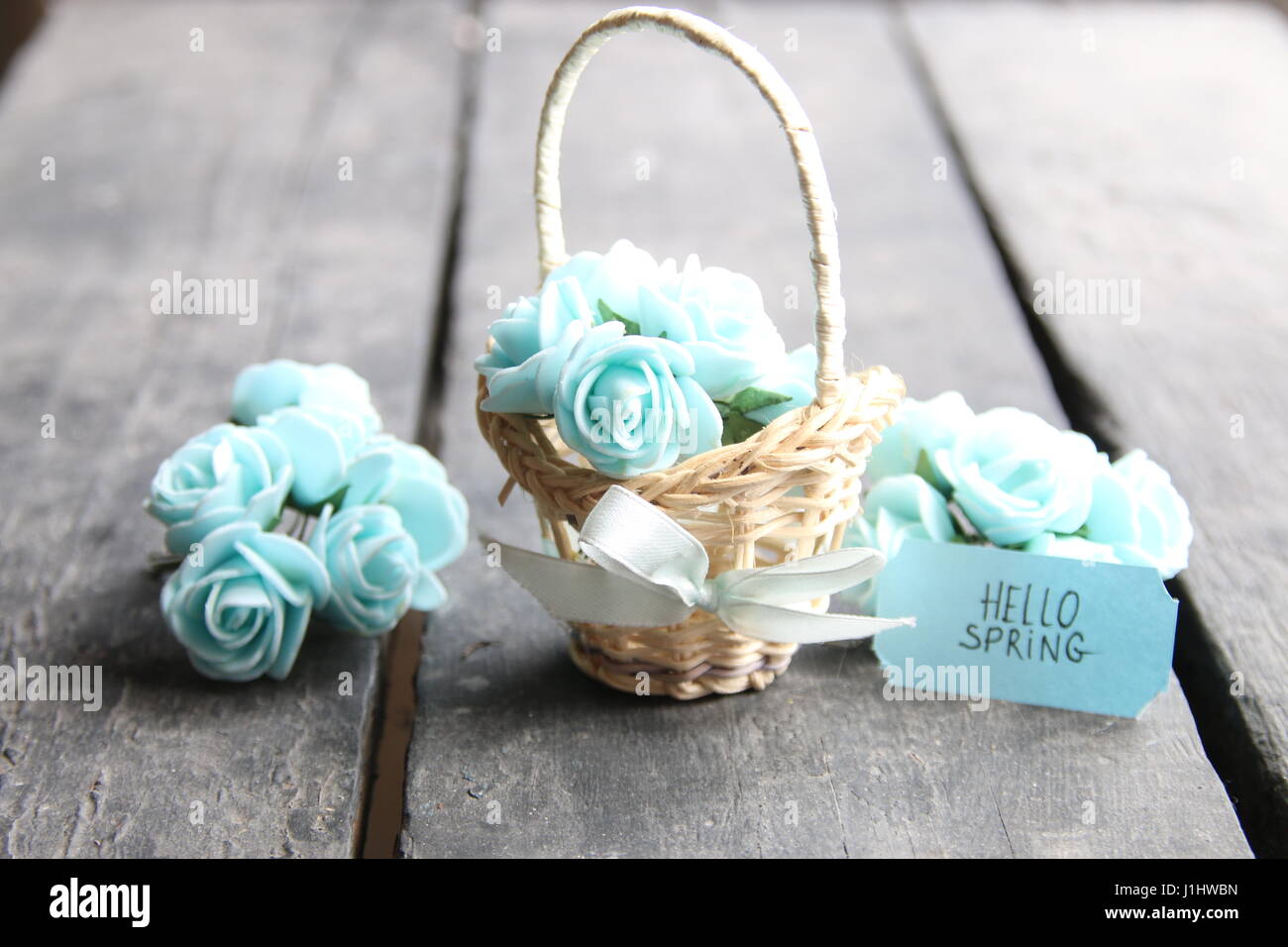hello spring tag and flowers in a small basket Stock Photo - Alamy