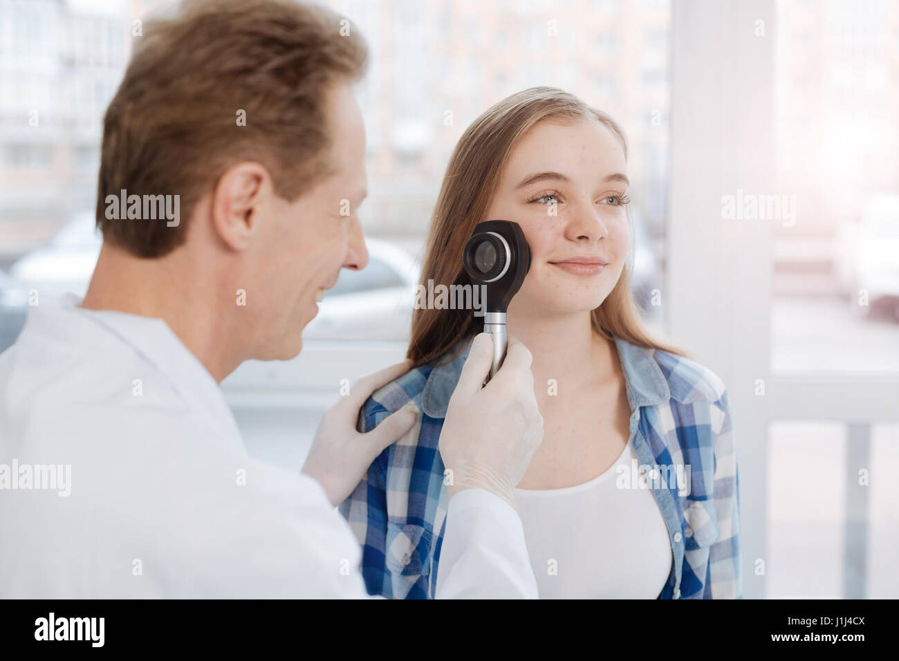 Experienced specialist exploring patient skin with dermatoscope in the ...