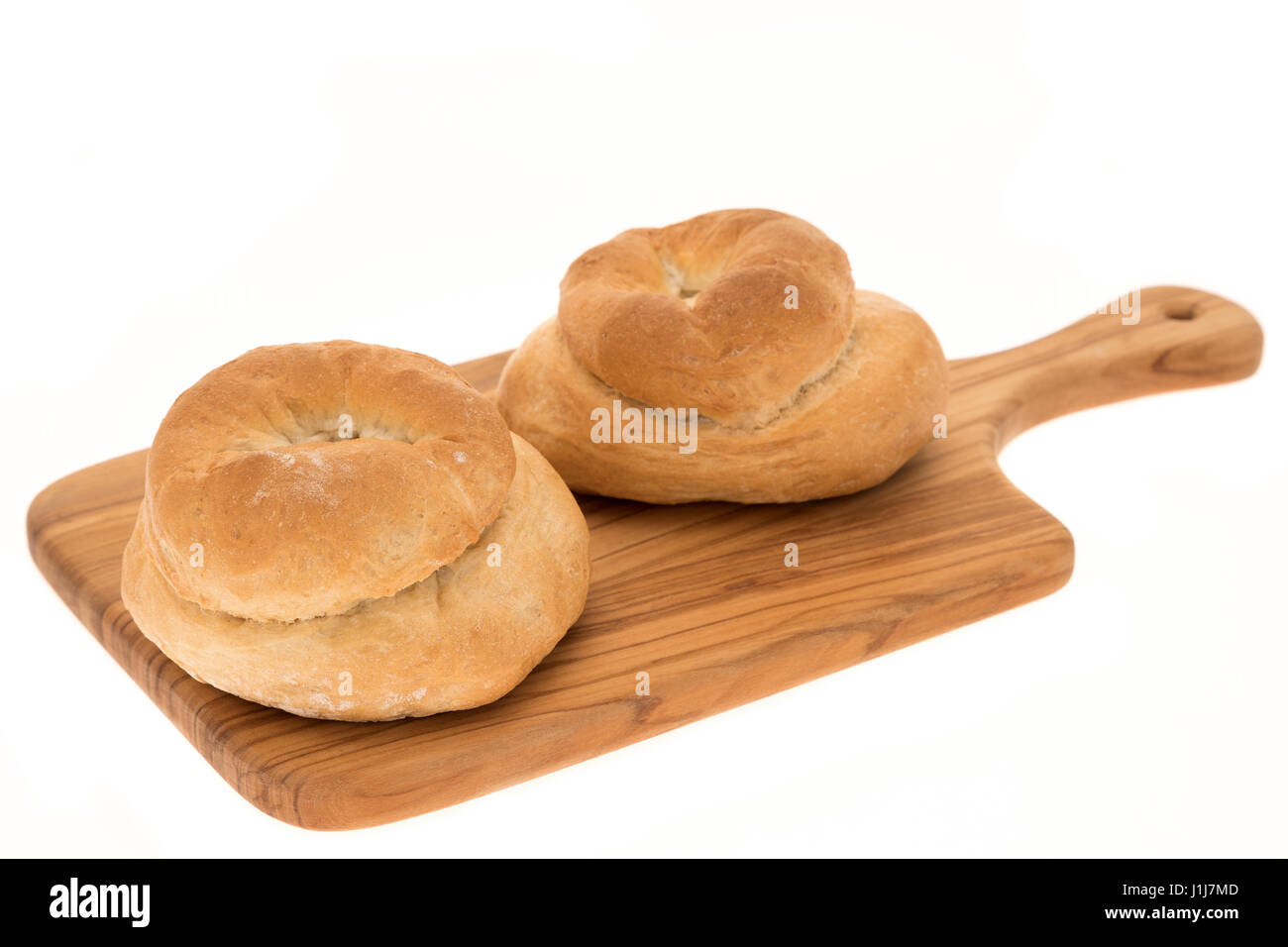 Two bread rolls on a cutting board - white background Stock Photo - Alamy