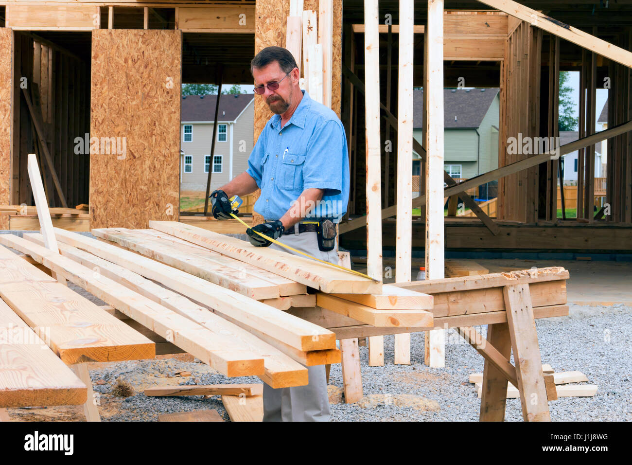 Carpenter inspecting wood before selecting the next support beam Stock ...