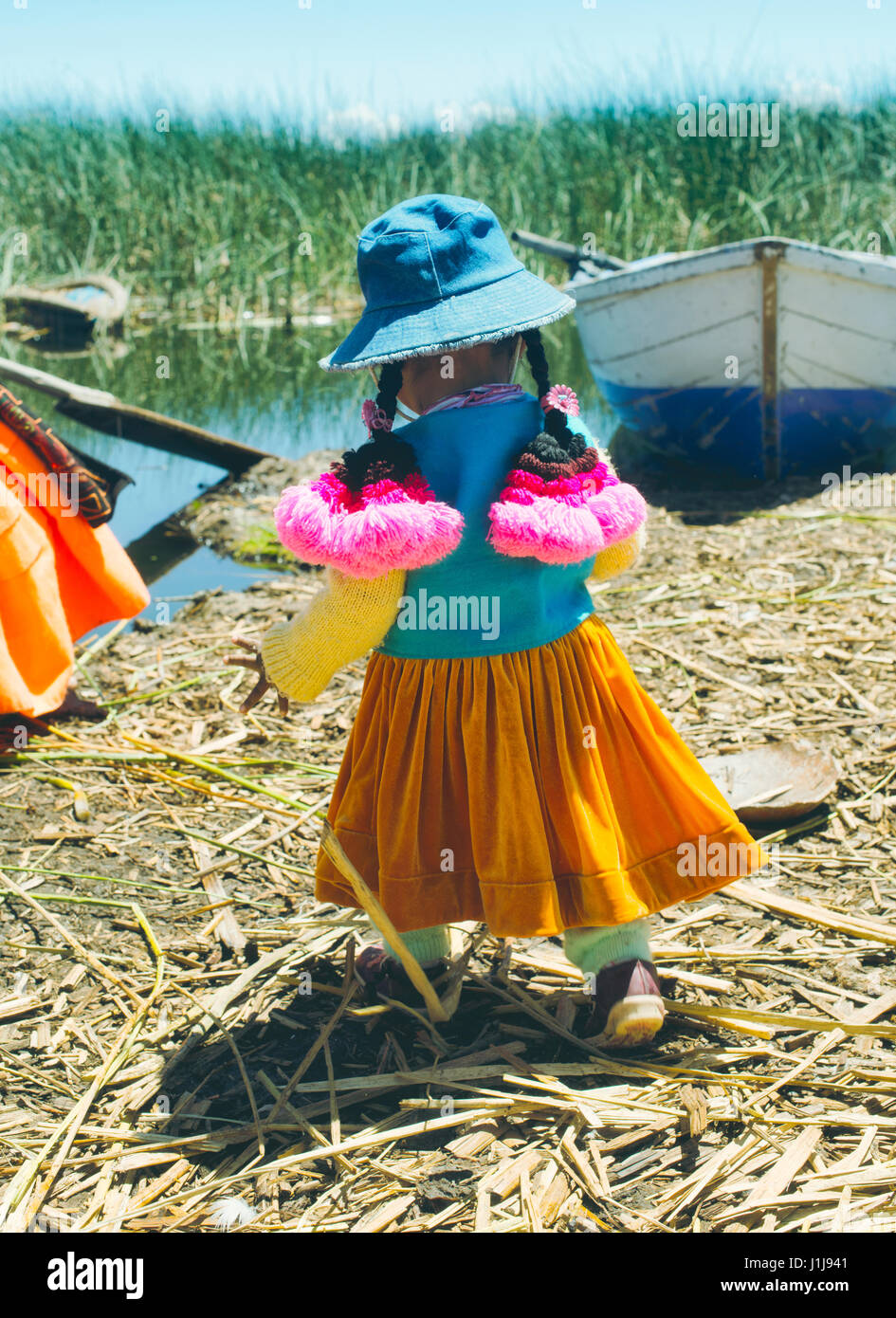 Aymara girl dressed in colorfull outfit, The Uros Islands. October 16 ...