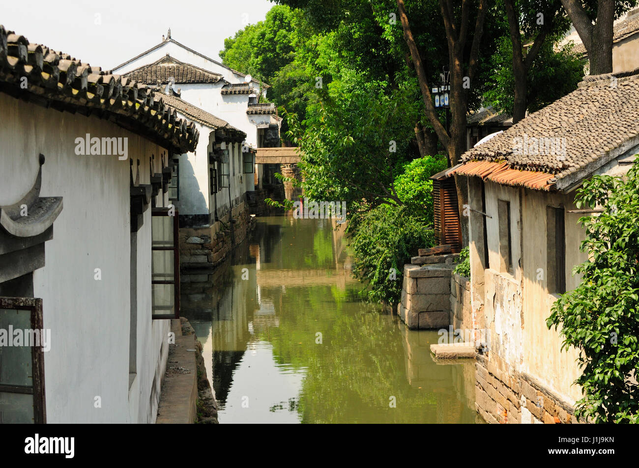 Weathered Chinese buildings line the water canals of Luzhi water town ...