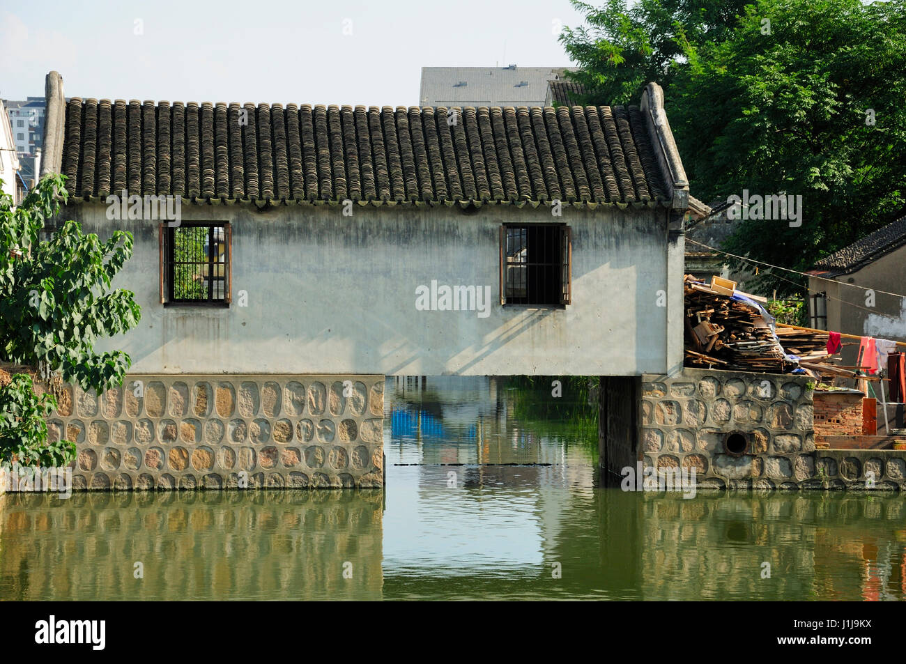 Weathered Chinese buildings line the water canals of Luzhi water town ...
