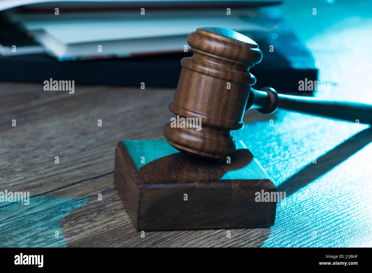 Judge's hammer on wooden table Stock Photo - Alamy