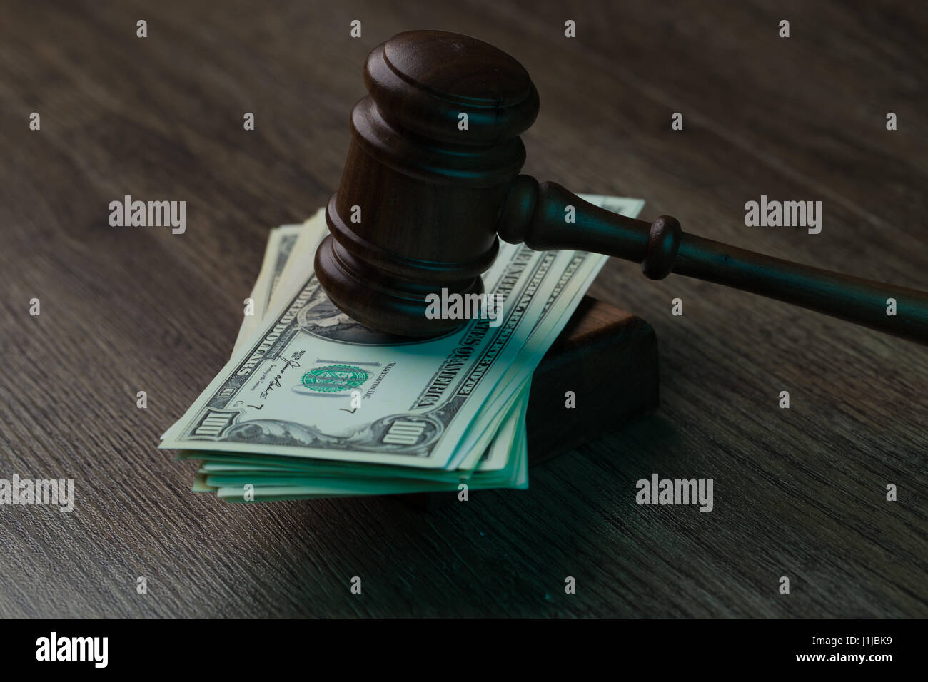 Hammer on dollars at table Stock Photo - Alamy