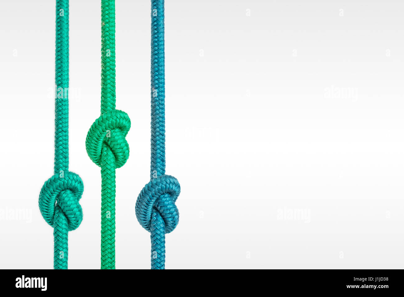 three knotted ropes isolated on white background Stock Photo - Alamy