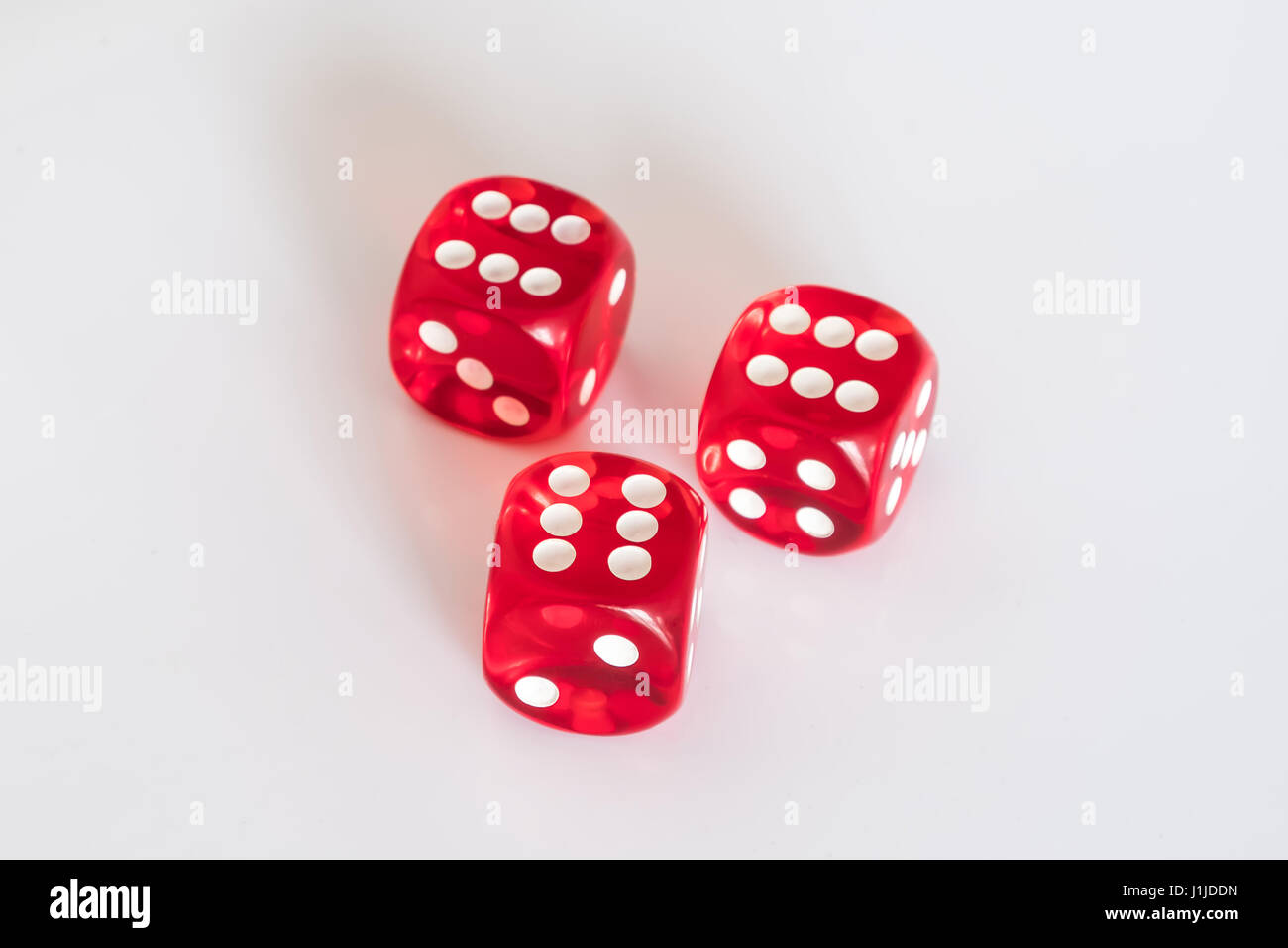 three dices showing six - red dice Stock Photo - Alamy