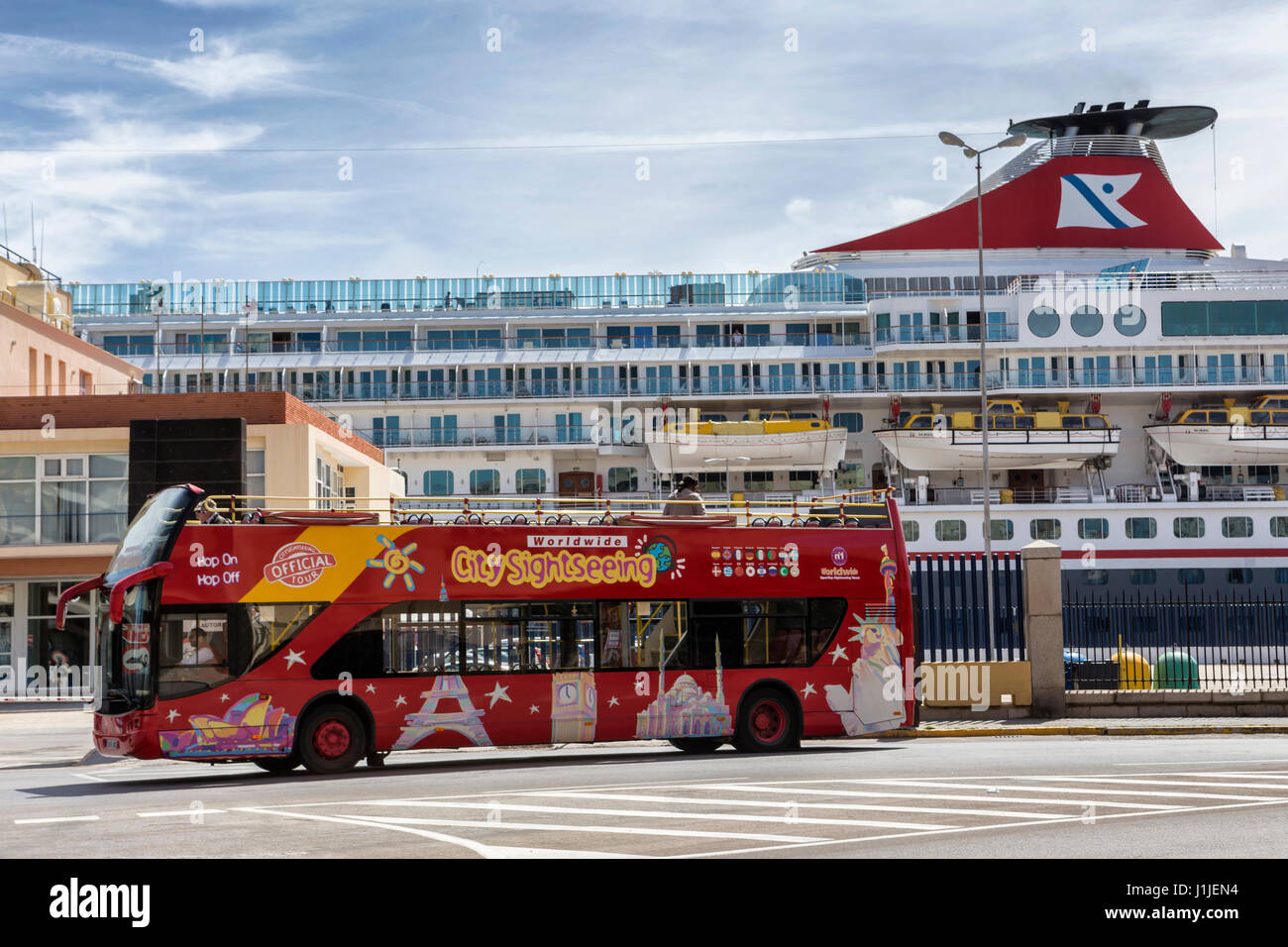 Brightly decorated sightseeing double-decker open top bus in Cadiz ...