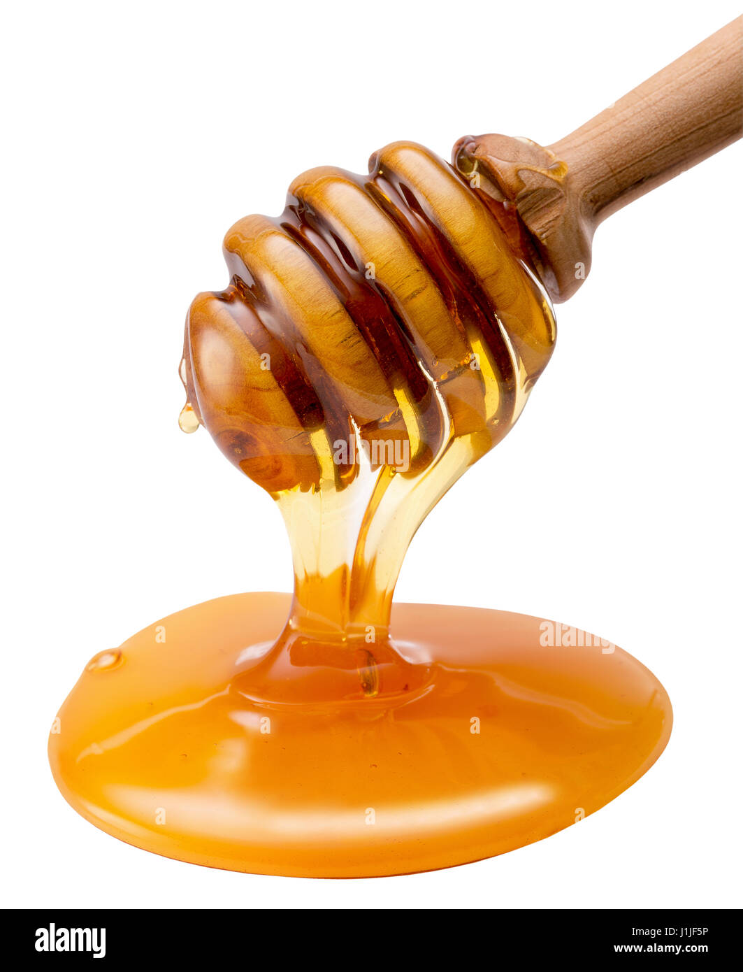 dropping honey isolated on a white background Stock Photo - Alamy