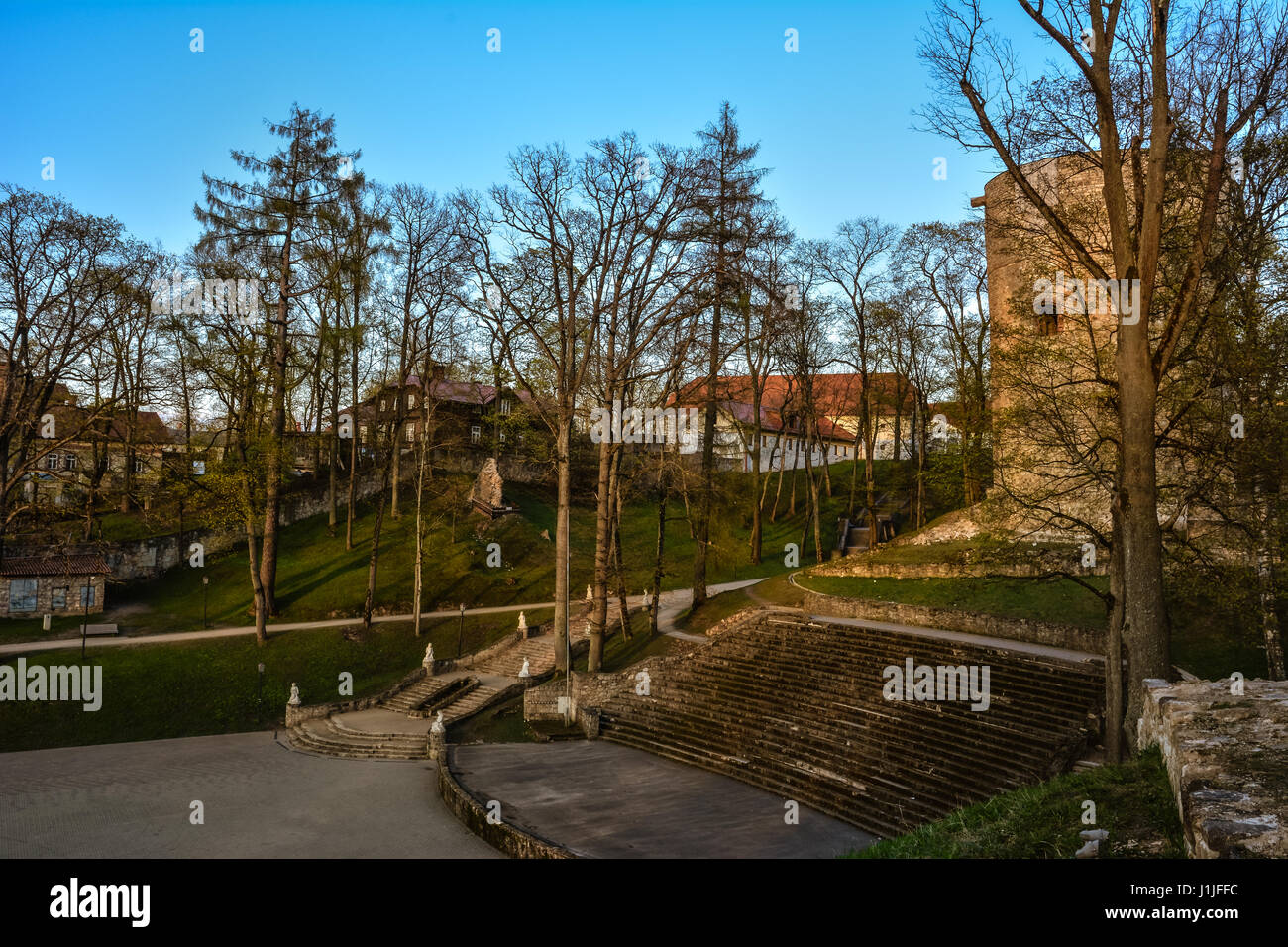 Beautiful afternoon light in public park with green grass and old ...