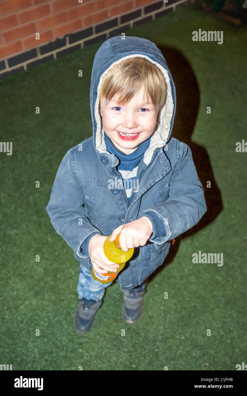 Blond boy looks at camera from bottom with smile Stock Photo - Alamy