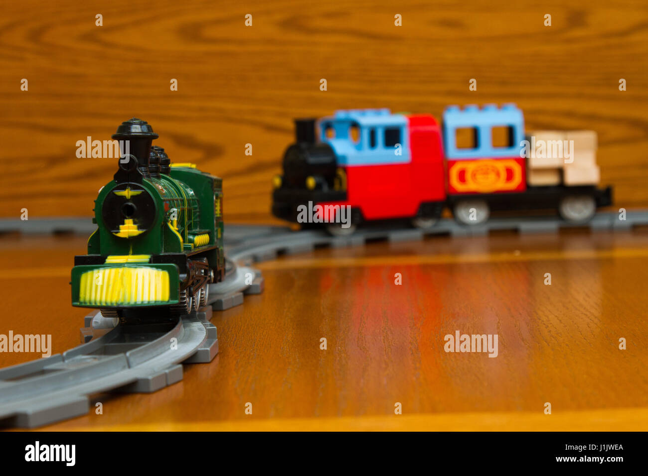 The toy train goes on rails. On a brown background Stock Photo - Alamy