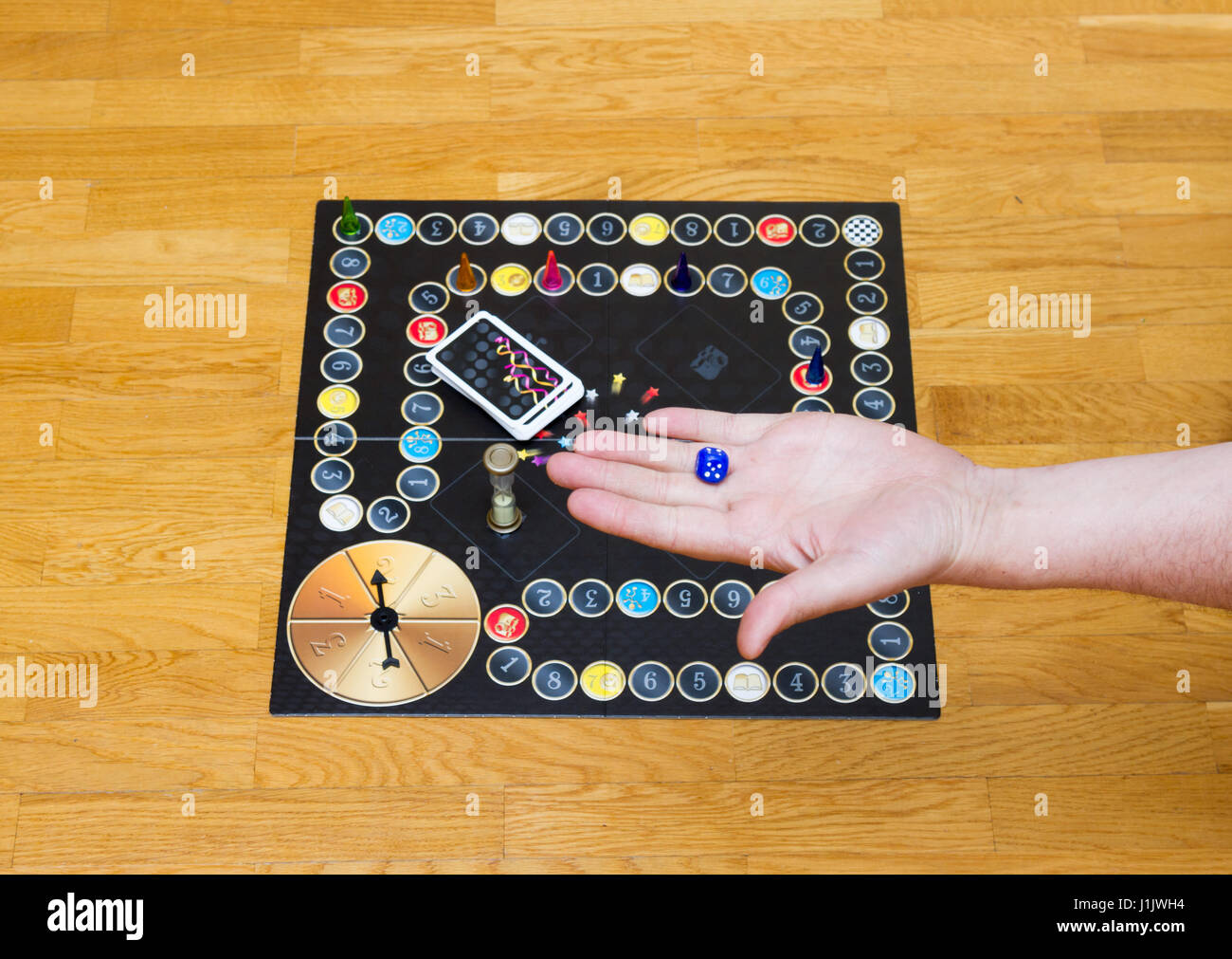 Board game. Hand with blue dice. casino Stock Photo - Alamy