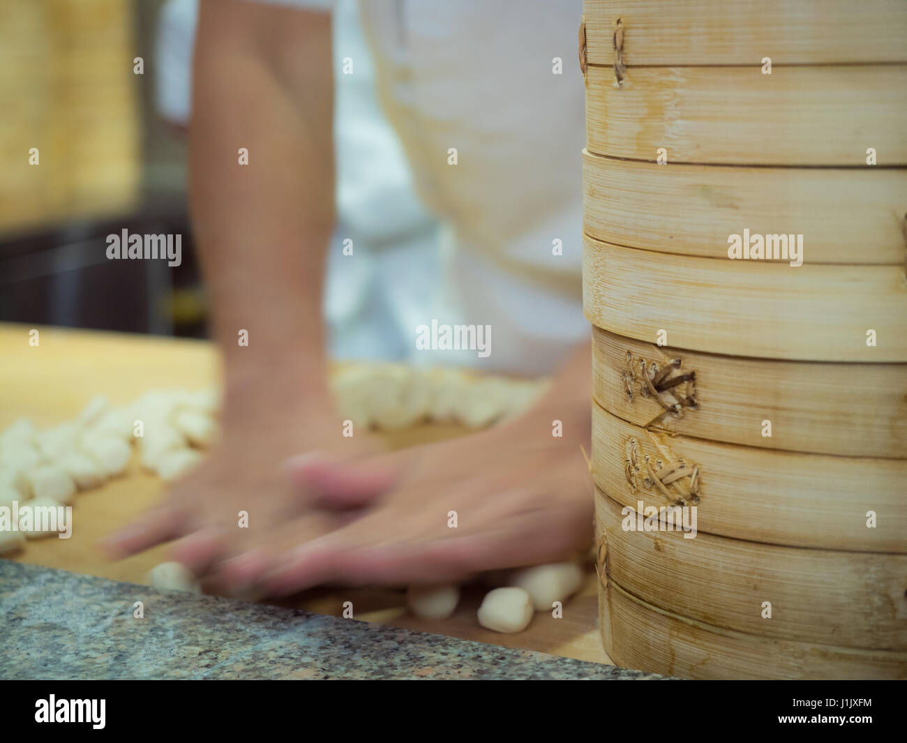 Dim sum bamboo basket containers with blur background of a chef Stock ...