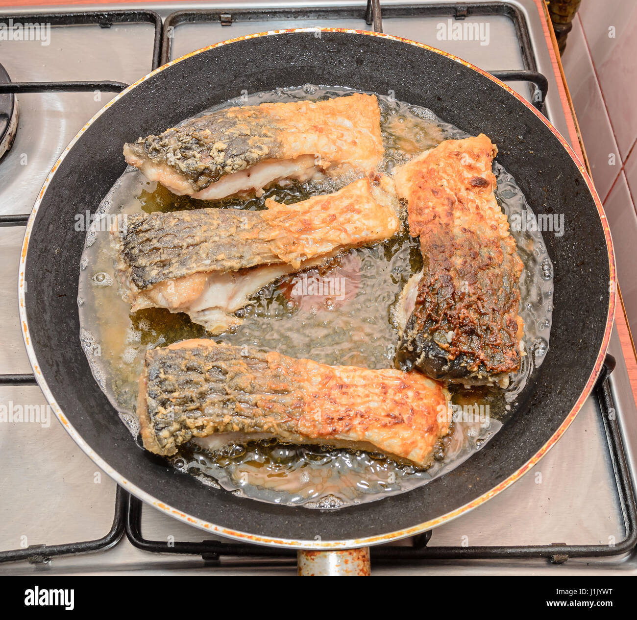 Carp fish meat fried in oil, crispy look, cooking pan close up Stock ...