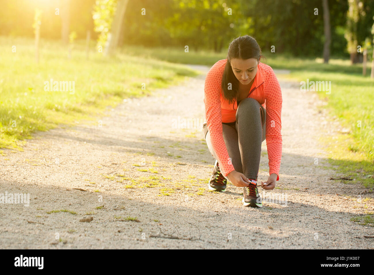 Runner fitness woman warming up Stock Photo - Alamy