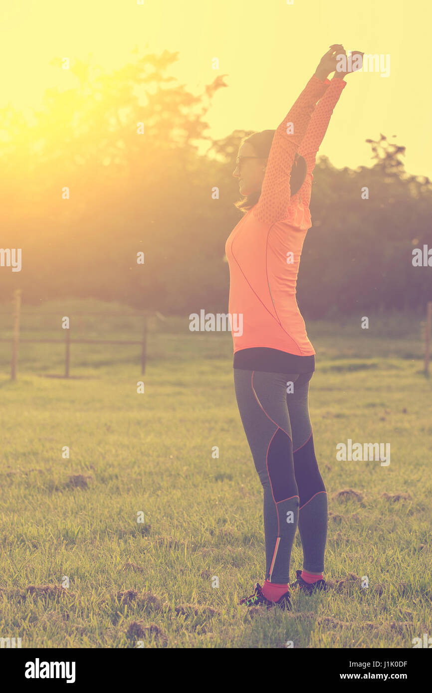 Runner fitness woman warming up Stock Photo - Alamy