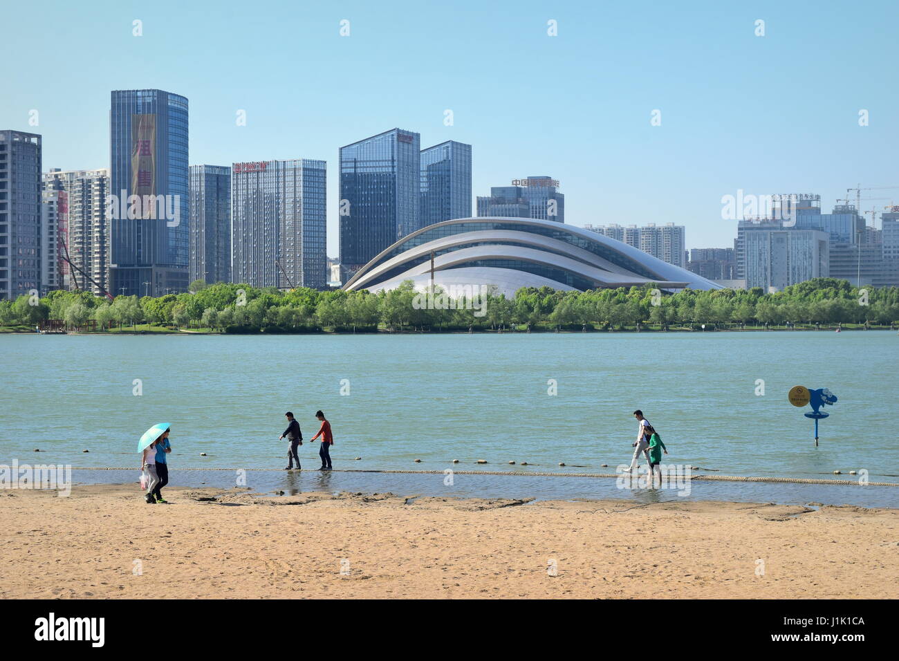 Urban growth and modern architecture by peaceful lake beach - Hefei ...