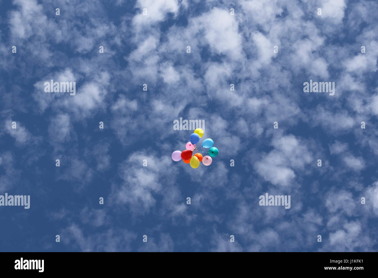 Bunch of colourful balloons floating away against a blue sky Stock ...