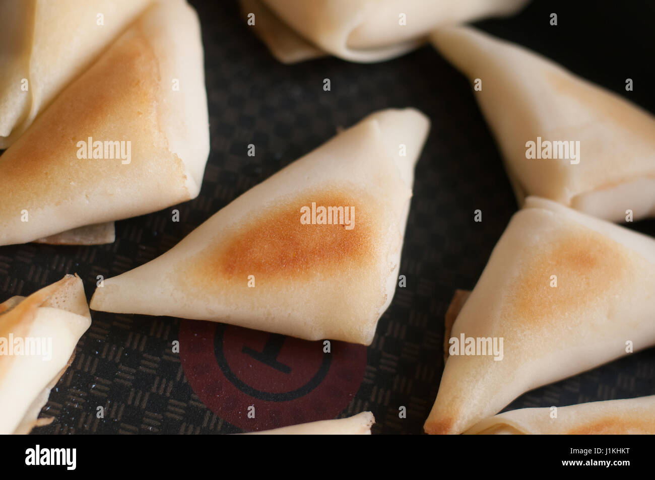 Many pancakes folded triangles on friyng pan almost top view Stock ...
